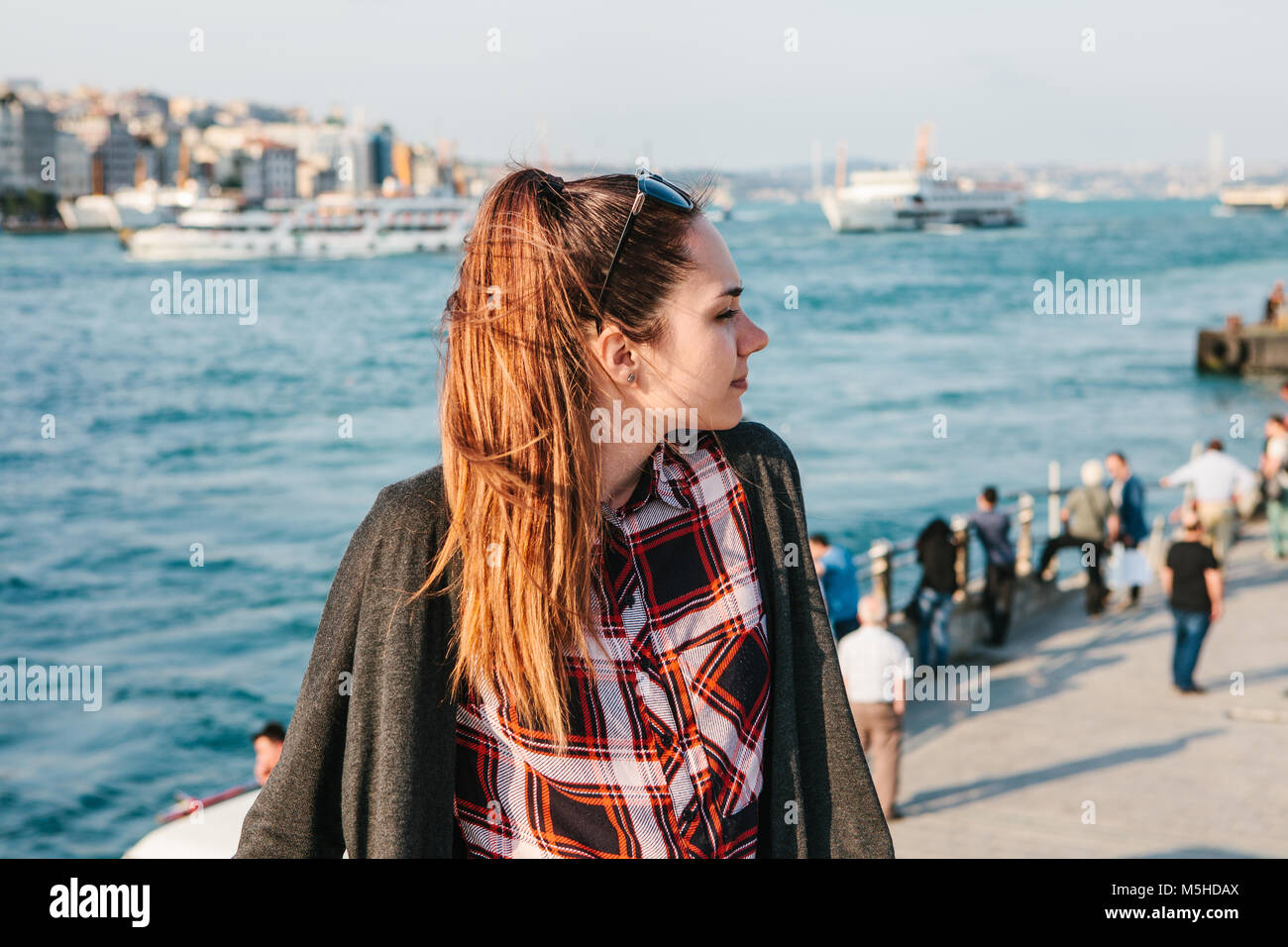 Beautiful young woman looking into the distance and enjoying beautiful ...