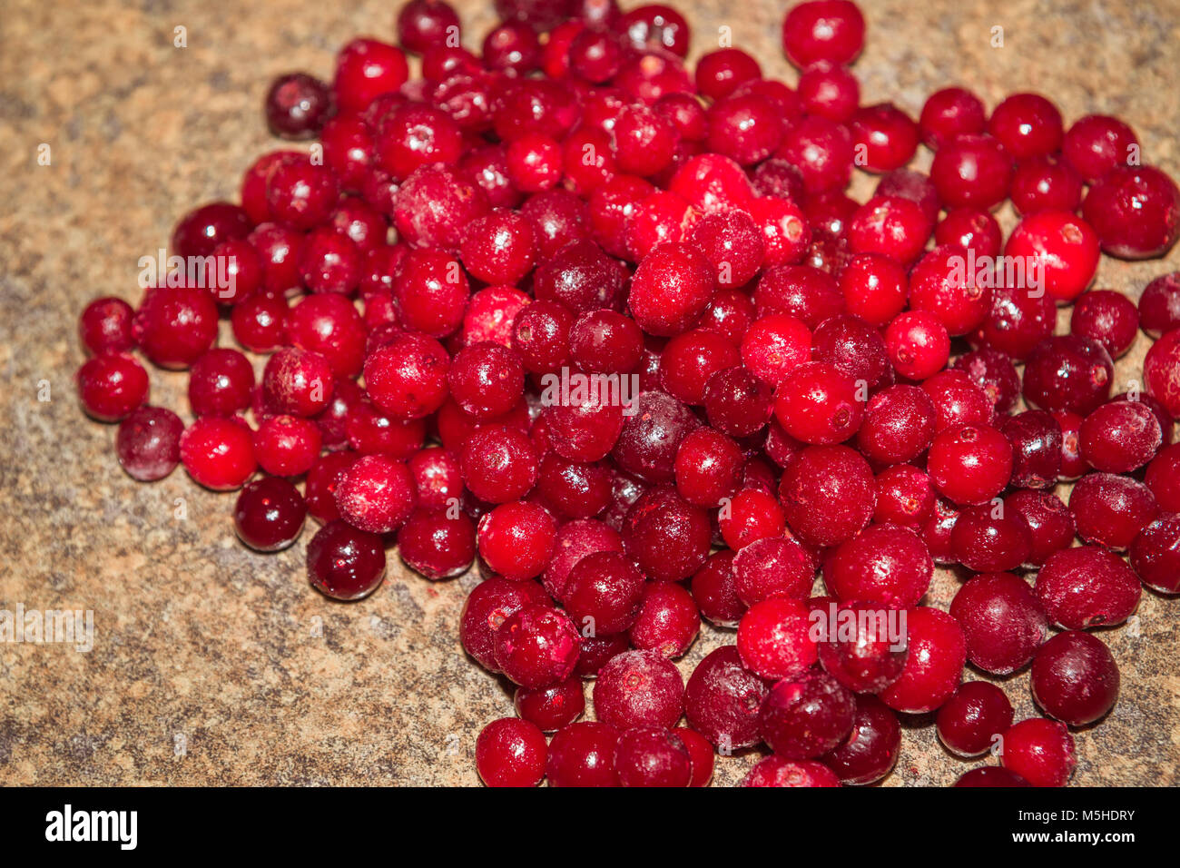 Cold frozen red berry cranberries on the table Stock Photo - Alamy