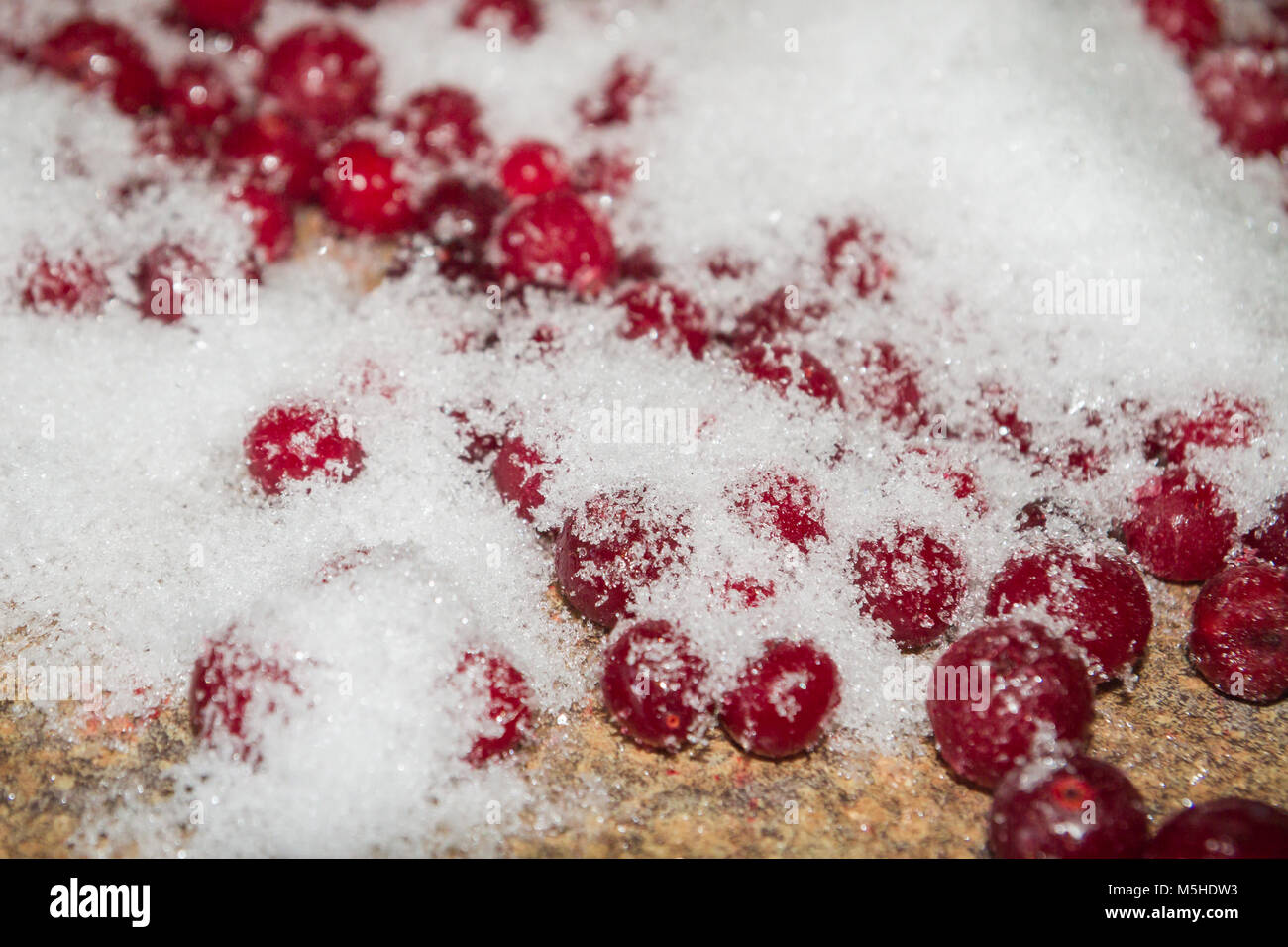 Cold frozen red berry cranberries on the table Stock Photo - Alamy
