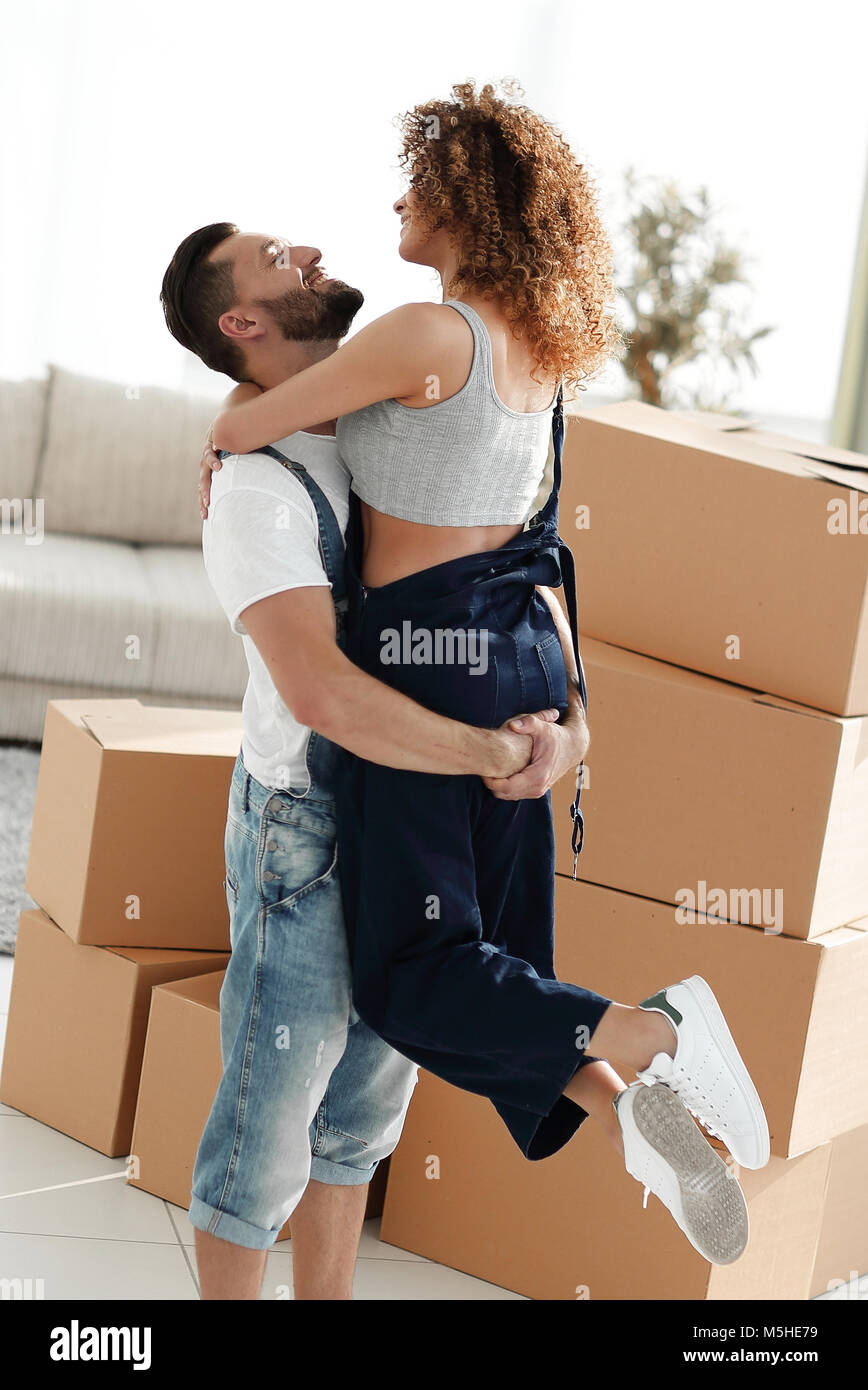 Hugging couple, against the background of boxes Stock Photo - Alamy