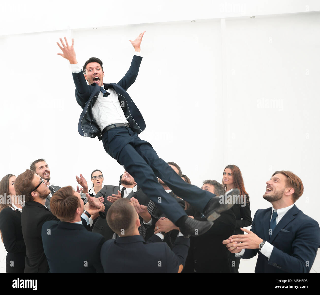large business team rocking their leader Stock Photo - Alamy
