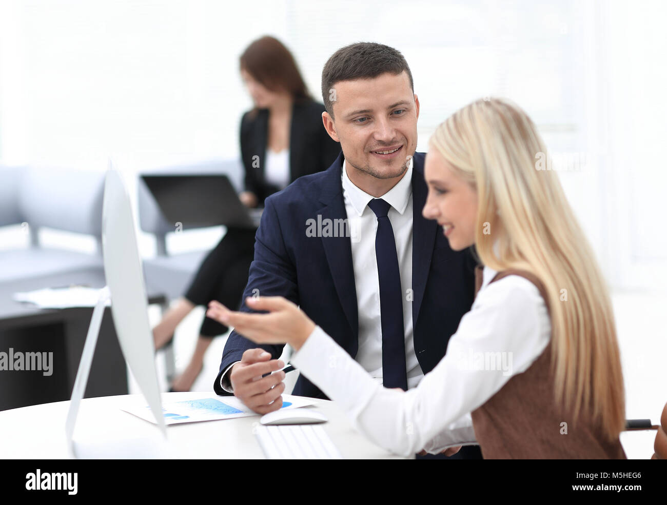 Manager talking with a colleague at the workplace Stock Photo - Alamy