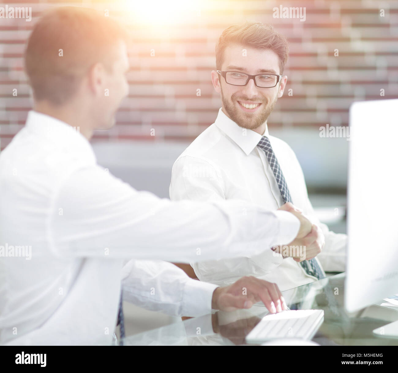 employees greet each other with a handshake Stock Photo - Alamy
