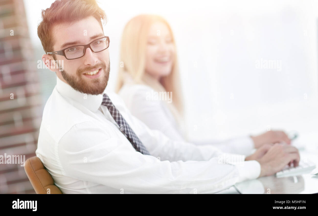 experienced programmer sitting in front of the monitor. office work ...