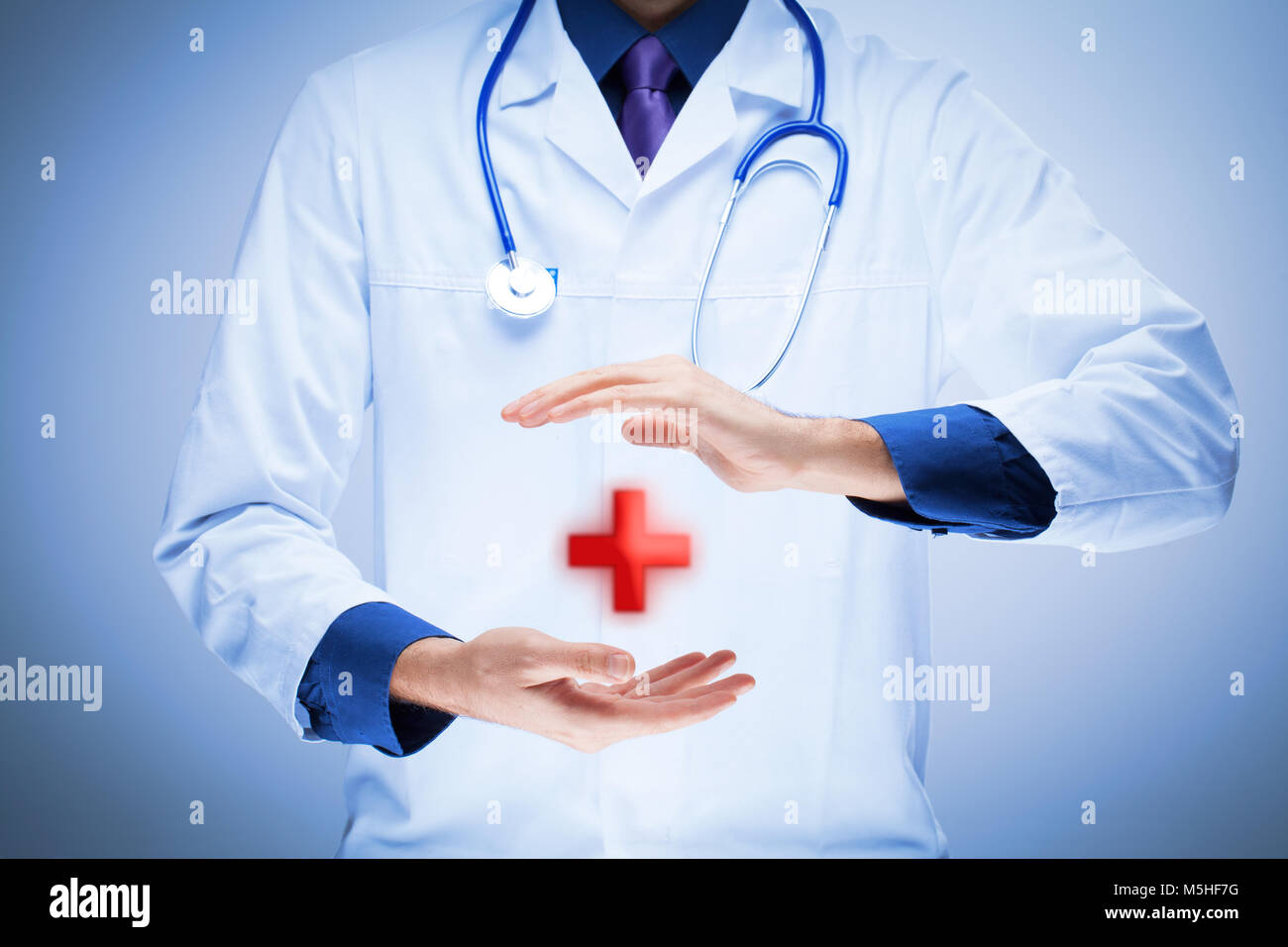 The doctor has in his hands the first aid symbol Stock Photo - Alamy