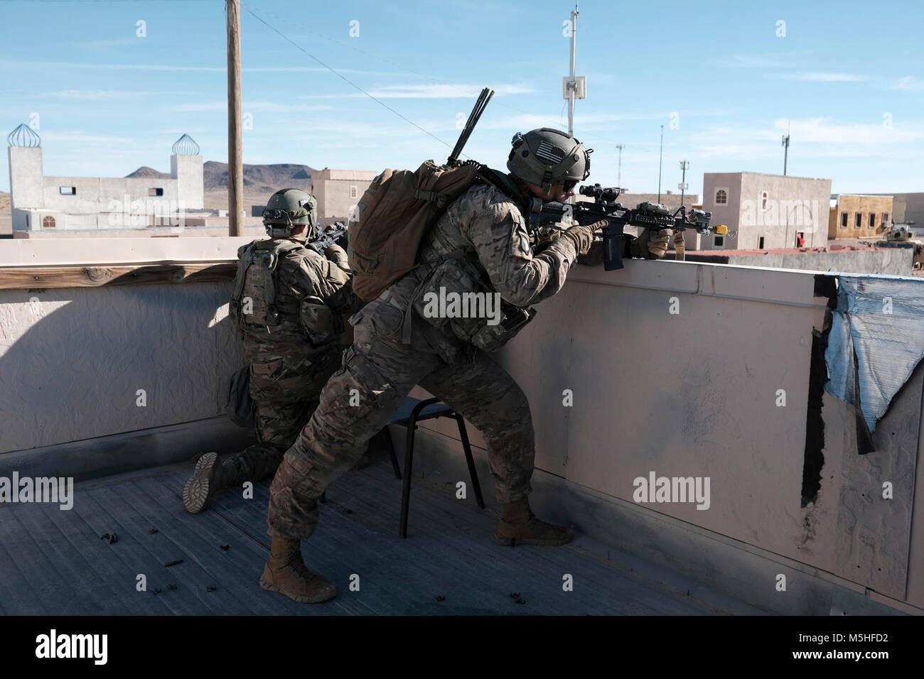 Staff Sgt. Craig Spangler and his team provide over watch as friendly ...