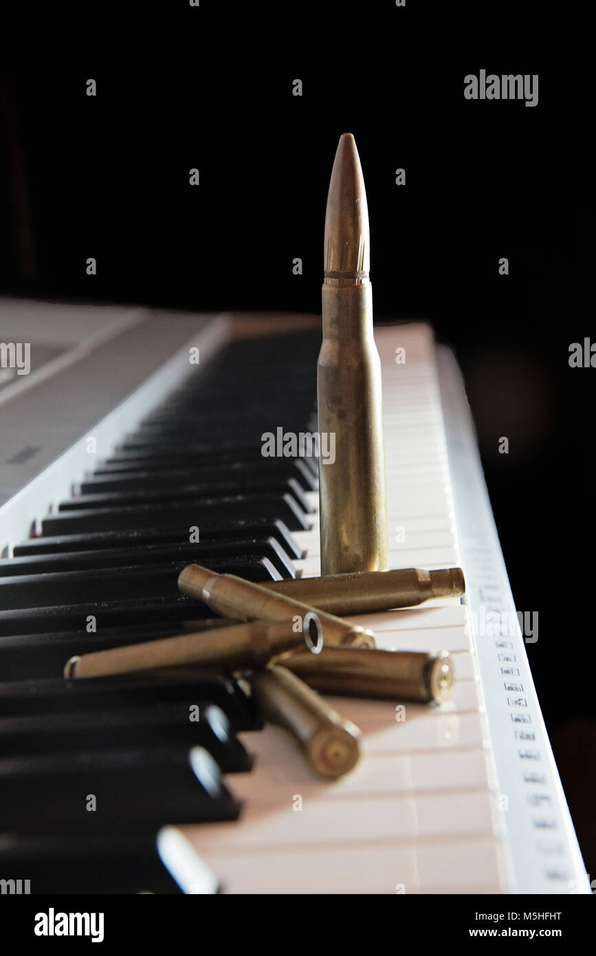 bullet shells on piano keys Stock Photo - Alamy
