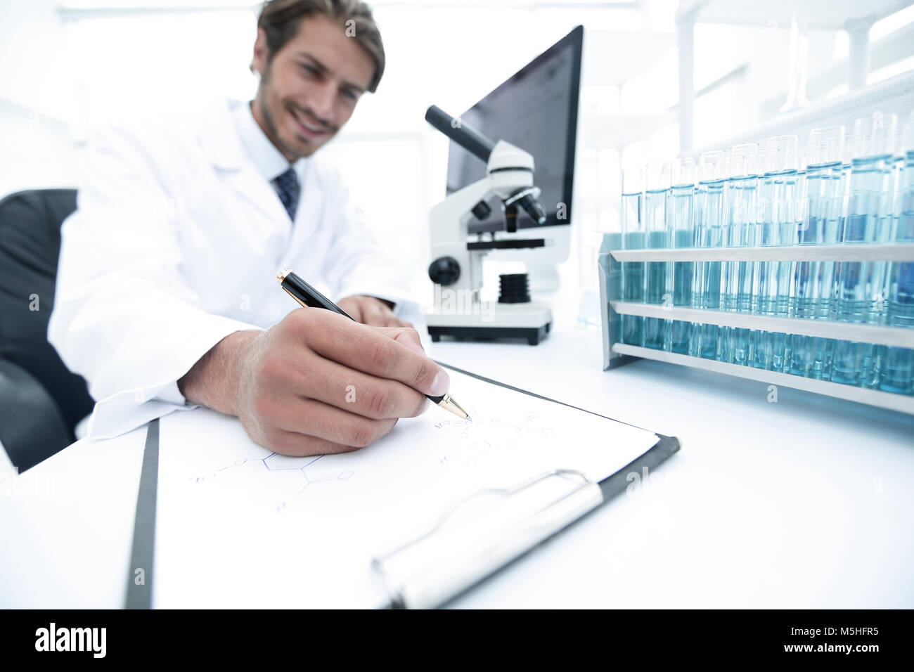 scientist makes a note of experiment in the laboratory Stock Photo - Alamy