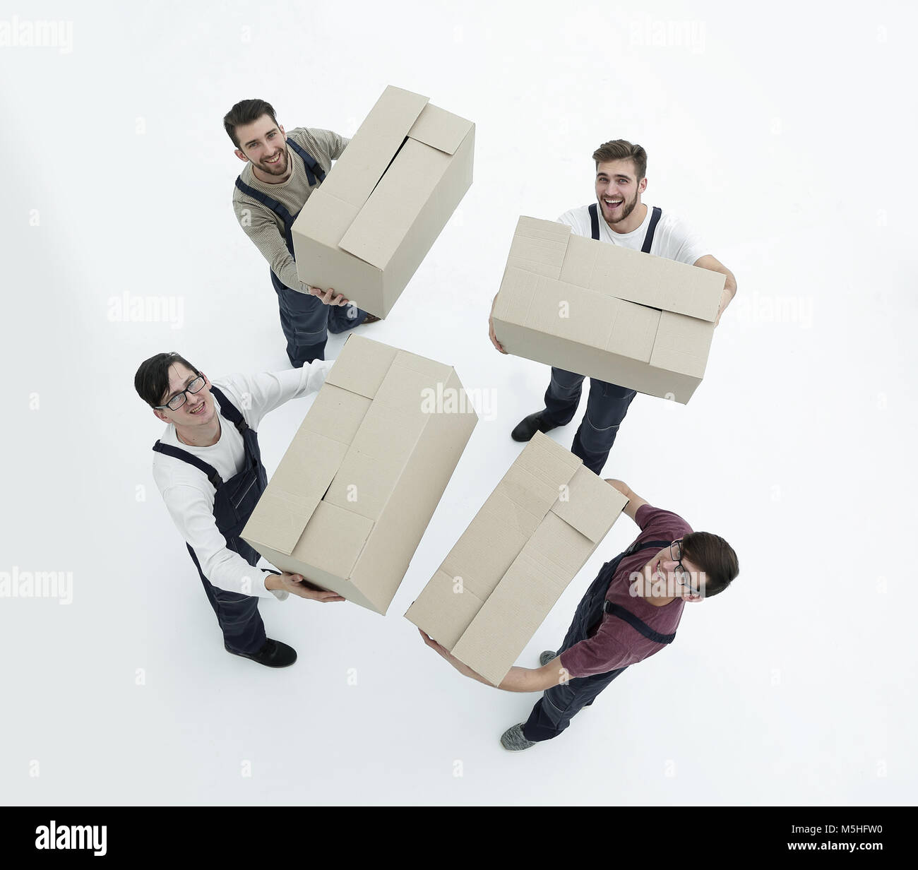 Movers lifting stack of cardboard moving boxes isolated on white Stock ...