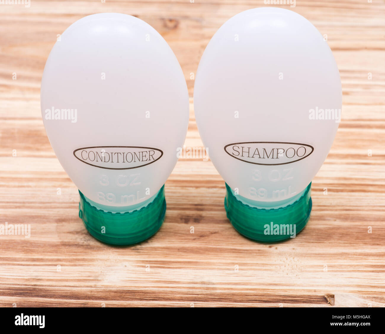 Travel size small plastic with green lids container Stock Photo - Alamy