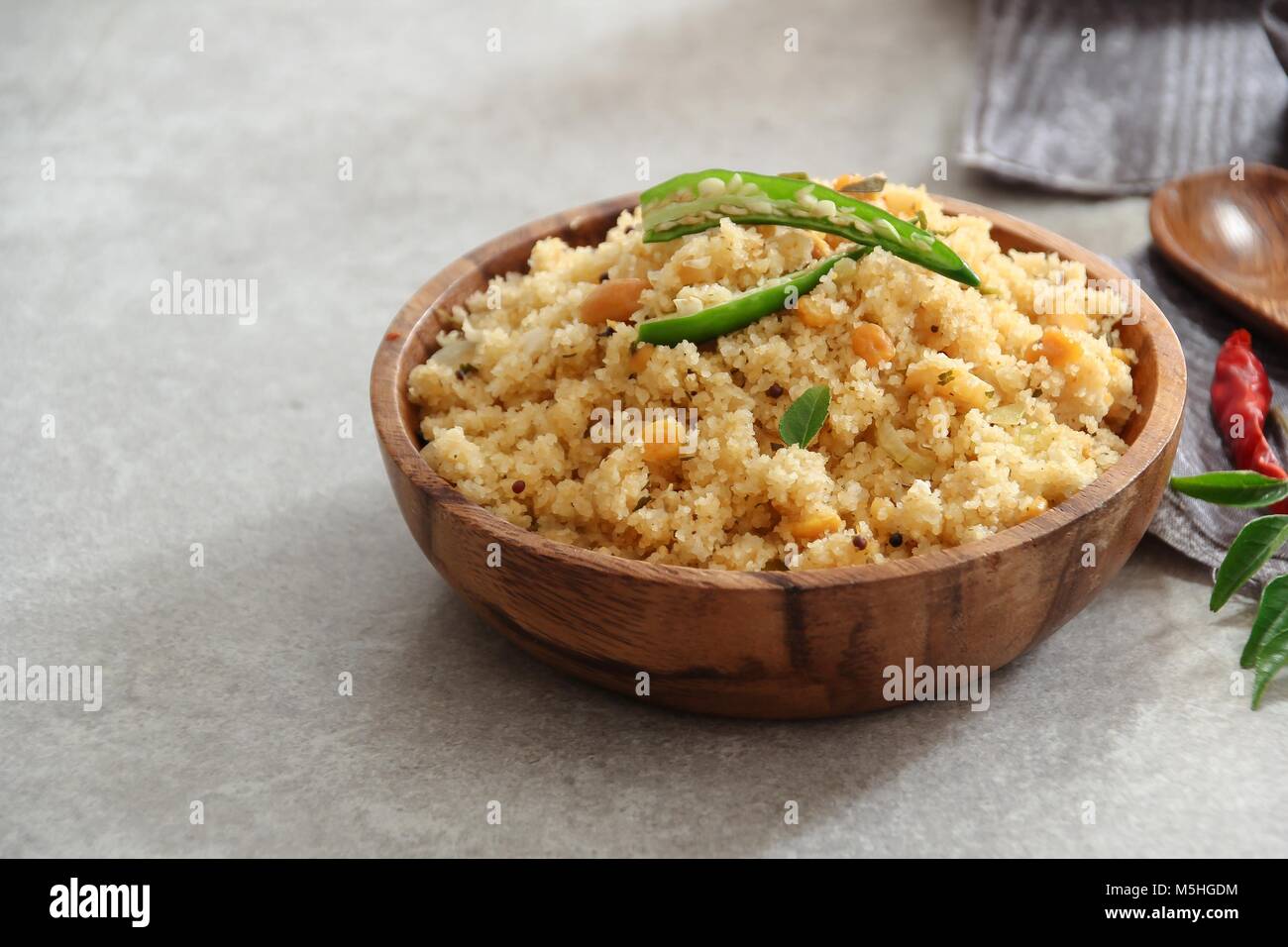 Rava Upma - south indian breakfast with semolina served in a wooden ...