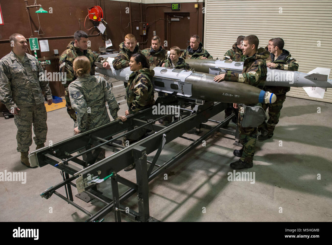 Air Force munitions crew chiefs with the 477th Maintenance Squadron are ...