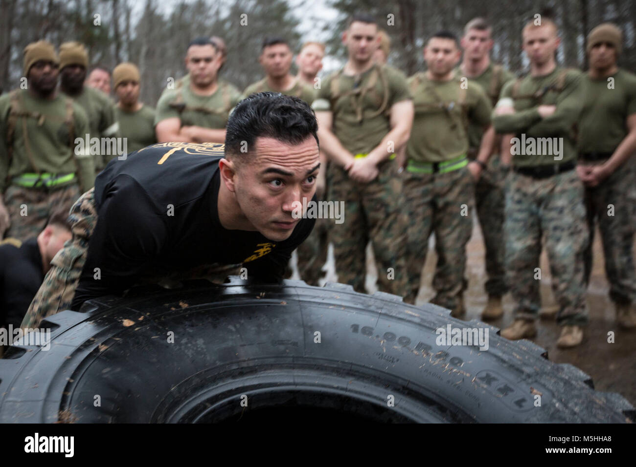 U.S. Marine Corps Staff Sgt. Richie Salinas demonstrates a tire flip ...