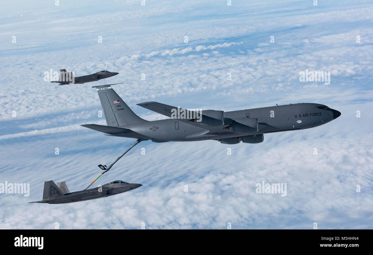 A KC-135 Stratotanker from the 101st Air Refueling Wing refuels F-22 ...