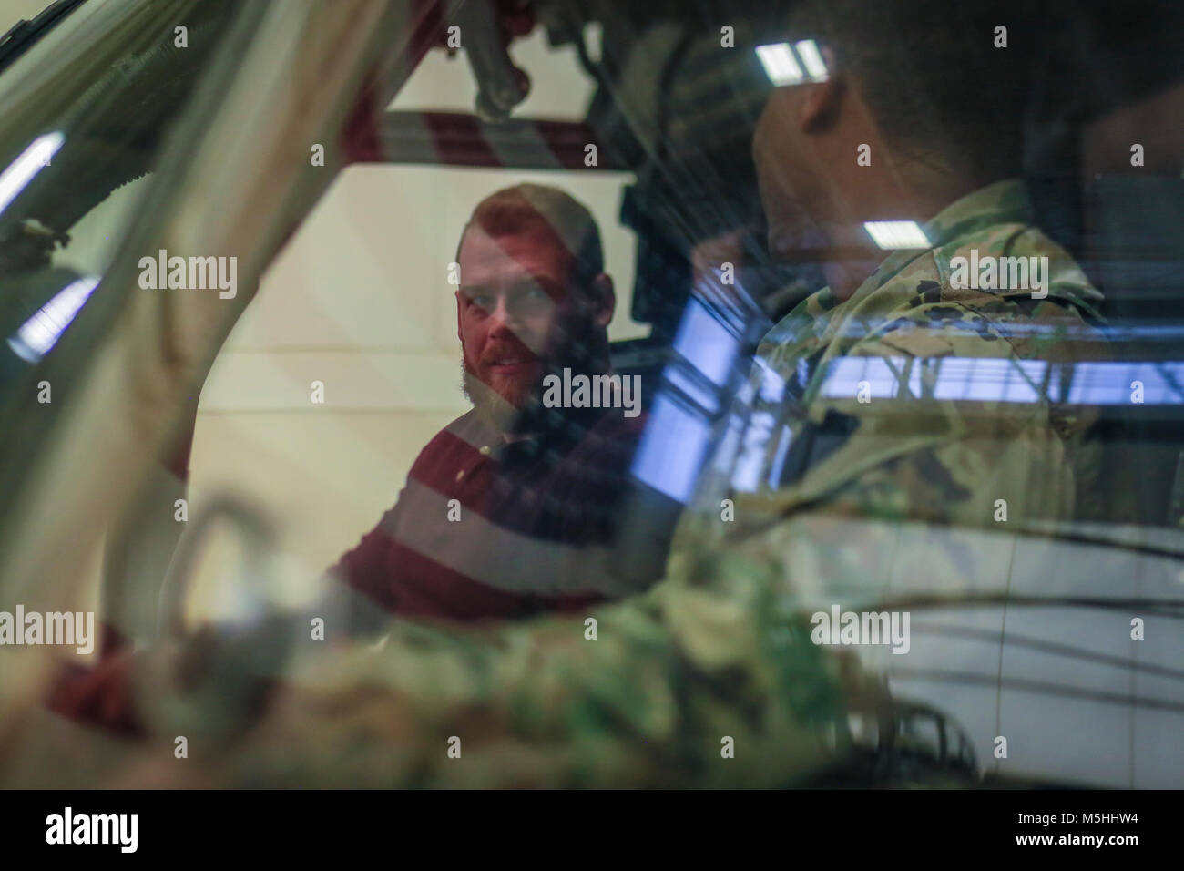 U.S. Army Capt. Andre Stevenson, right, gives Cpl. Rory Hamill, a ...