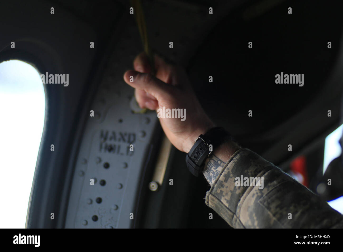 Cpl. Rory Hamill, a combat-wounded Marine, holds onto an overhead strap ...