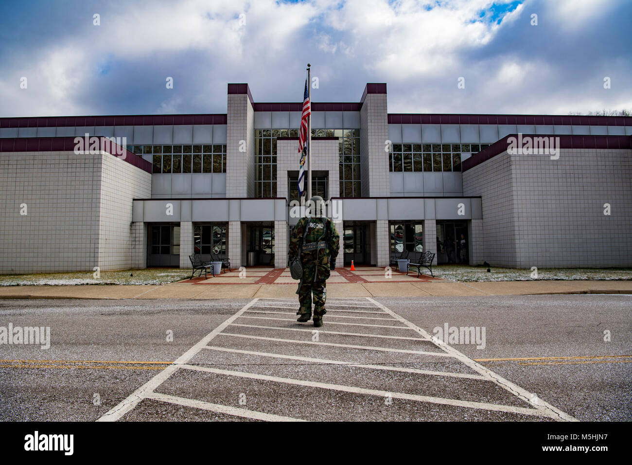 A U.S. Air Force Airman from the 130th Airlift Wing walks back into the ...