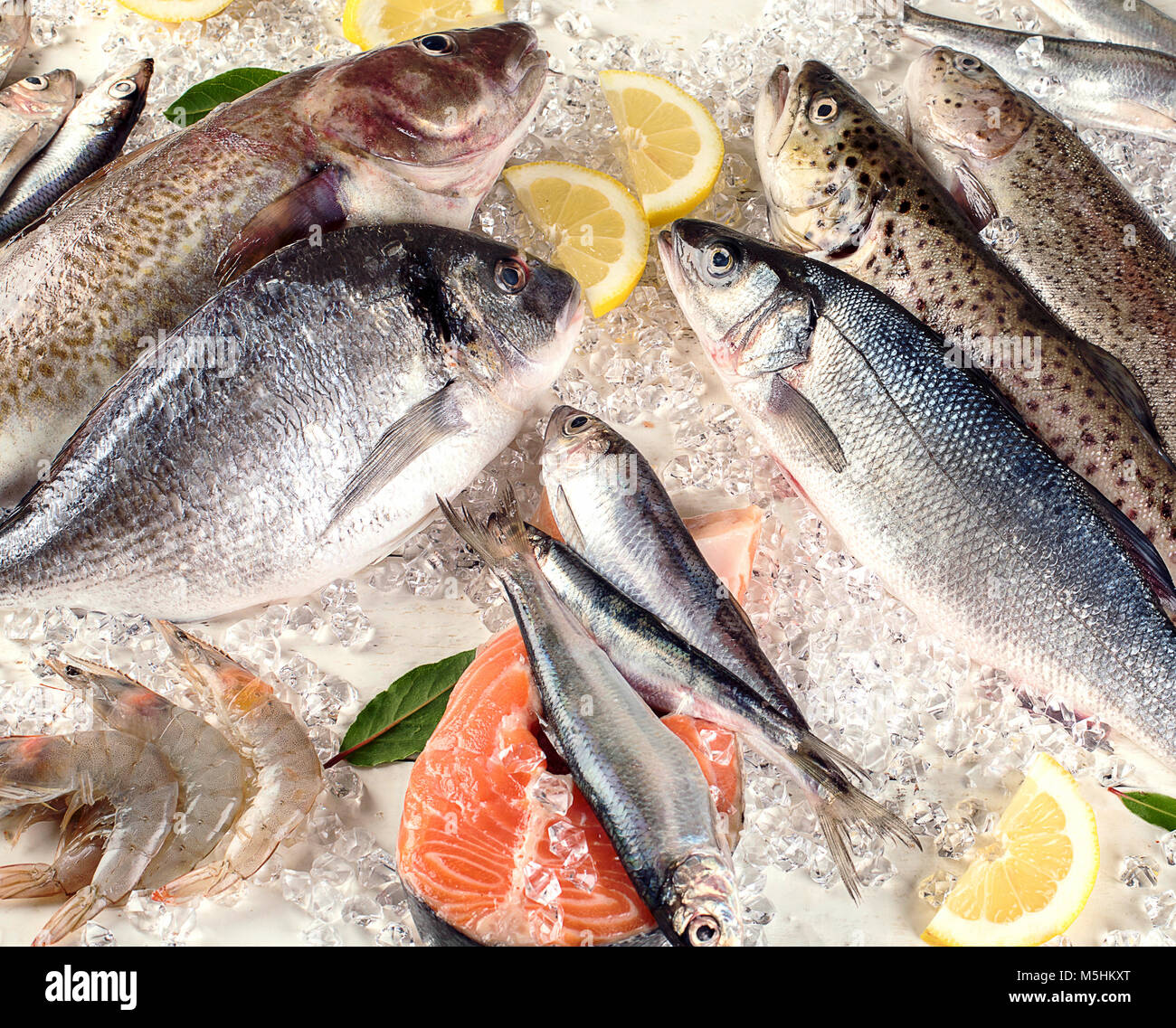 Fresh fish and seafood on white wooden background. Healthy eating. Top ...