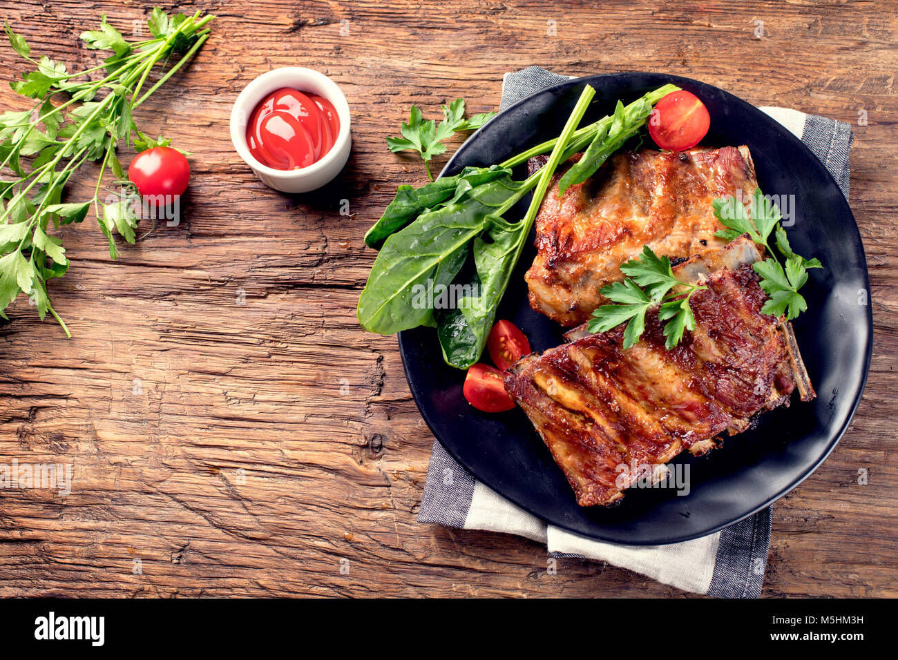 Barbecue spare ribs on an rustic wooden table Stock Photo - Alamy