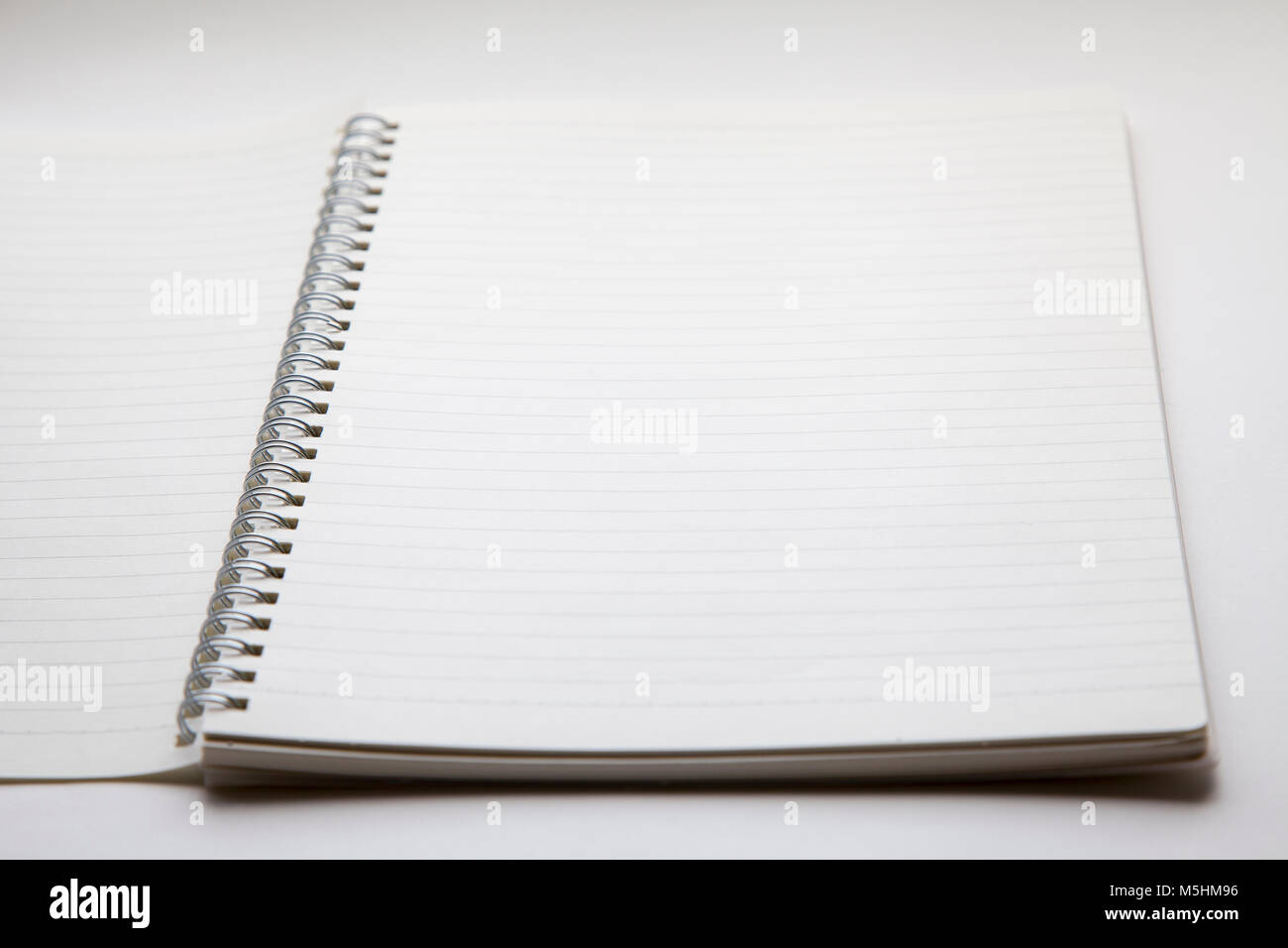 blank open spiral notebook isolated on white background,selective ...