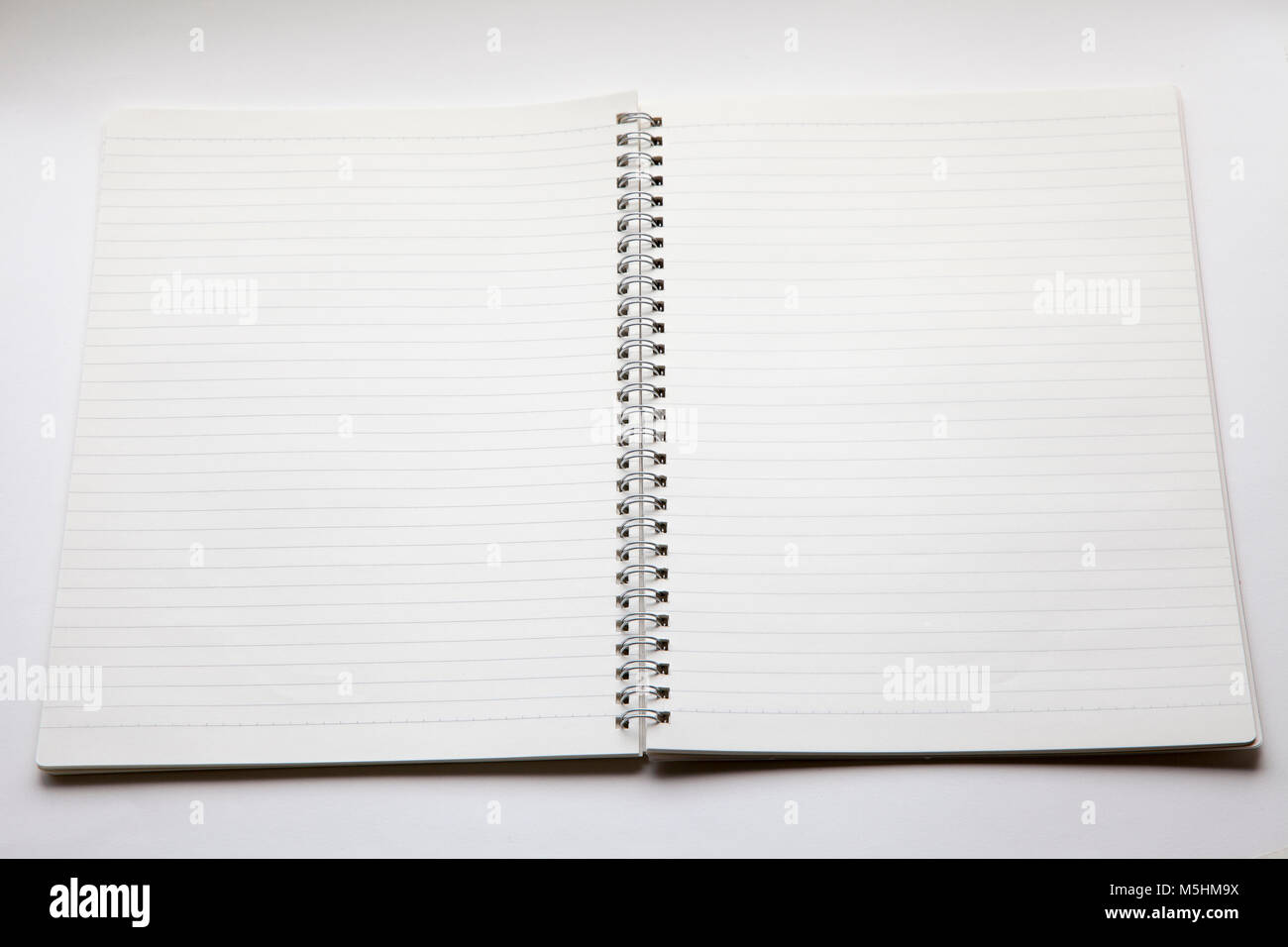 blank open spiral notebook isolated on white background,selective ...