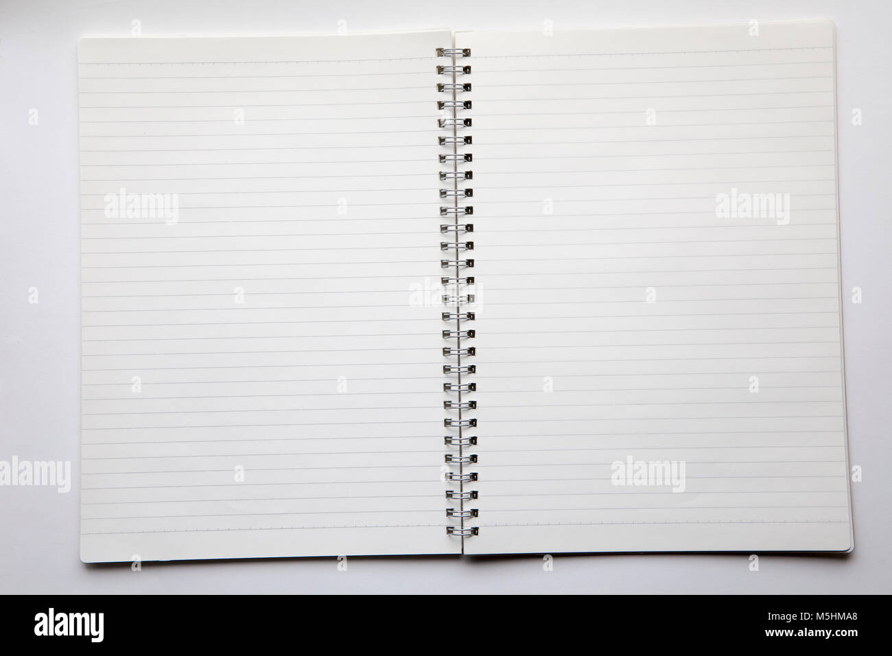 blank open spiral notebook isolated on white background,selective ...