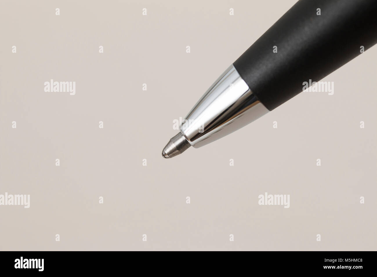 black ballpoint pen nib,on a white notebook background Stock Photo - Alamy