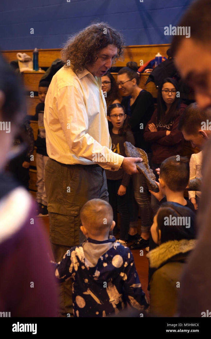 Eddy Collier, shows children a dinosaur fossil before starting the ...