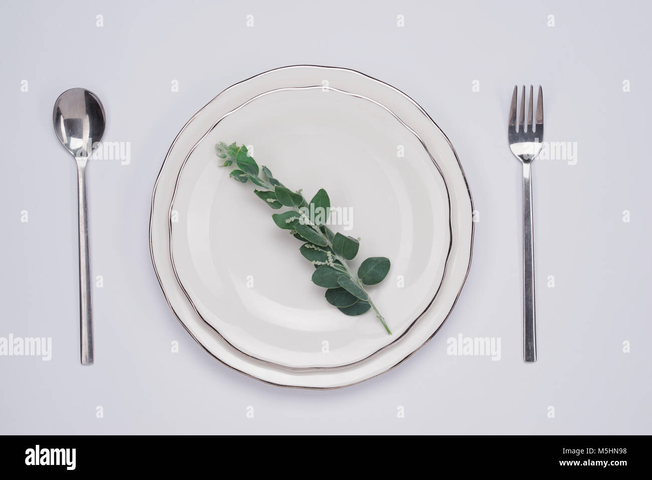 Dinner plate setting top view. Empty plate and silverware set on wooden ...