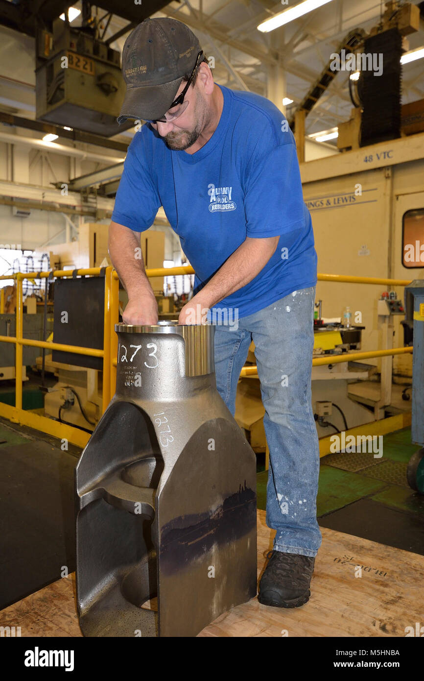 Arsenal Machinist Harold Mosher is inspecting a muzzle brake that will ...