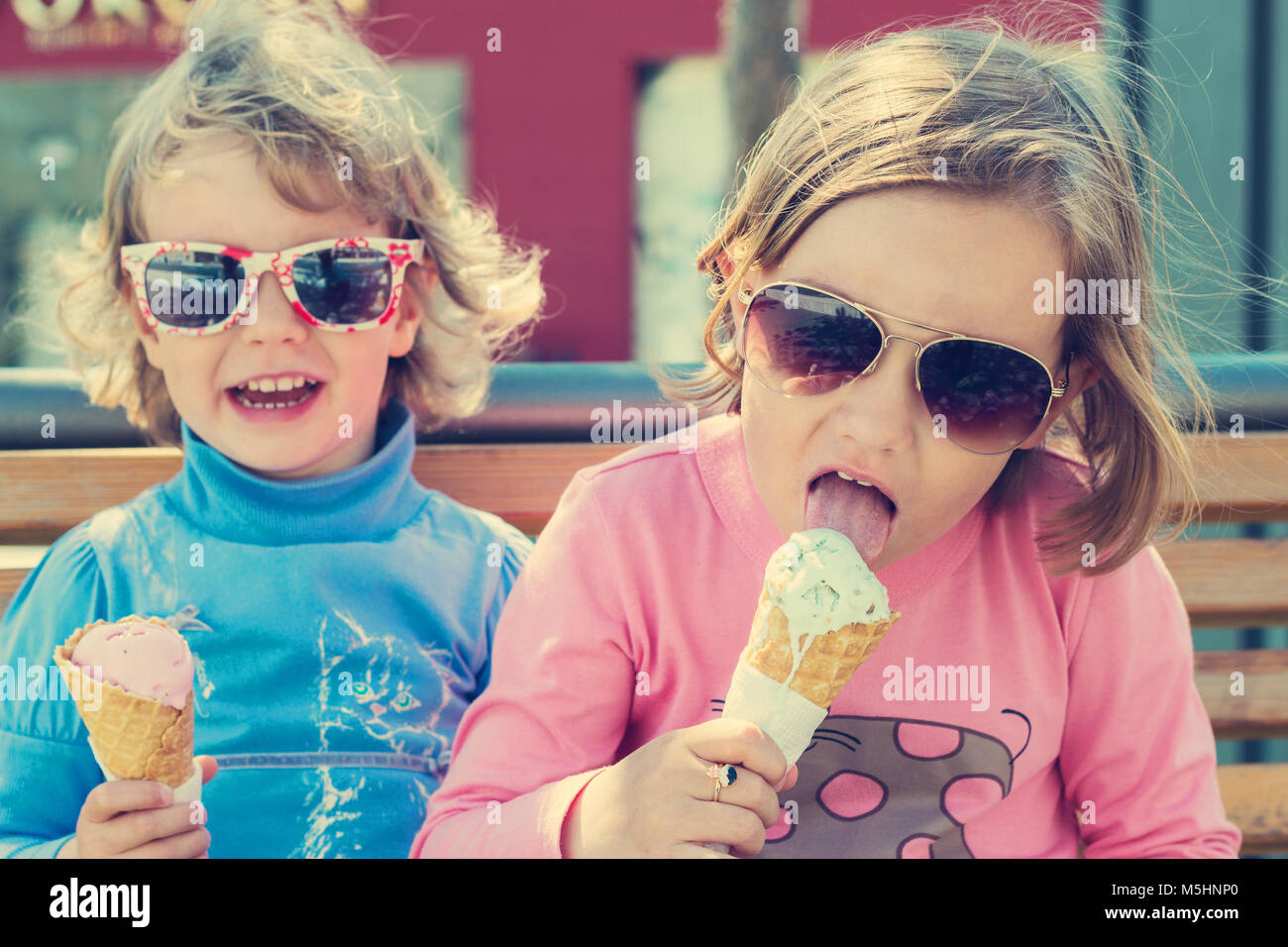 Two little girls (sisters) eating ice cream Stock Photo - Alamy Two little girls (sisters) eating ice cream Stock Photo - Alamy