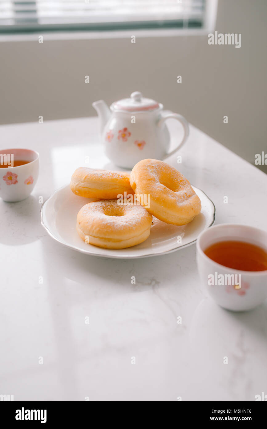 sugar donut and tea on white background Stock Photo - Alamy