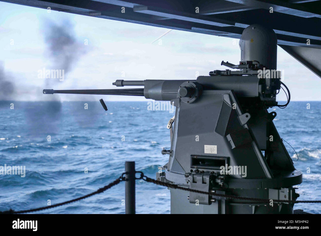 OCEAN (Feb. 8, 2018) An Mk-38 fires a 25mm round at a smoke target ...