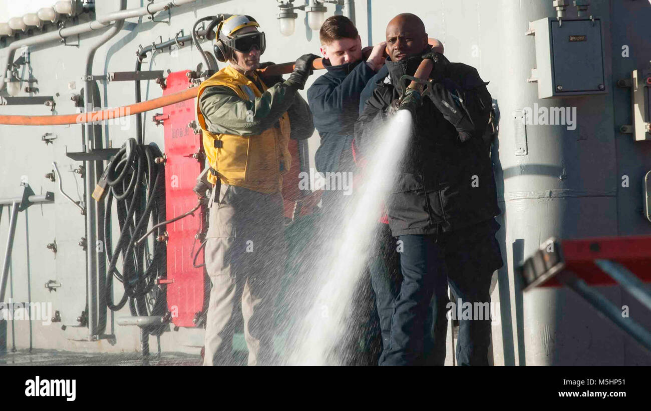 OCEAN (Feb. 8, 2018) Sailors spray the flight deck during a flight deck ...