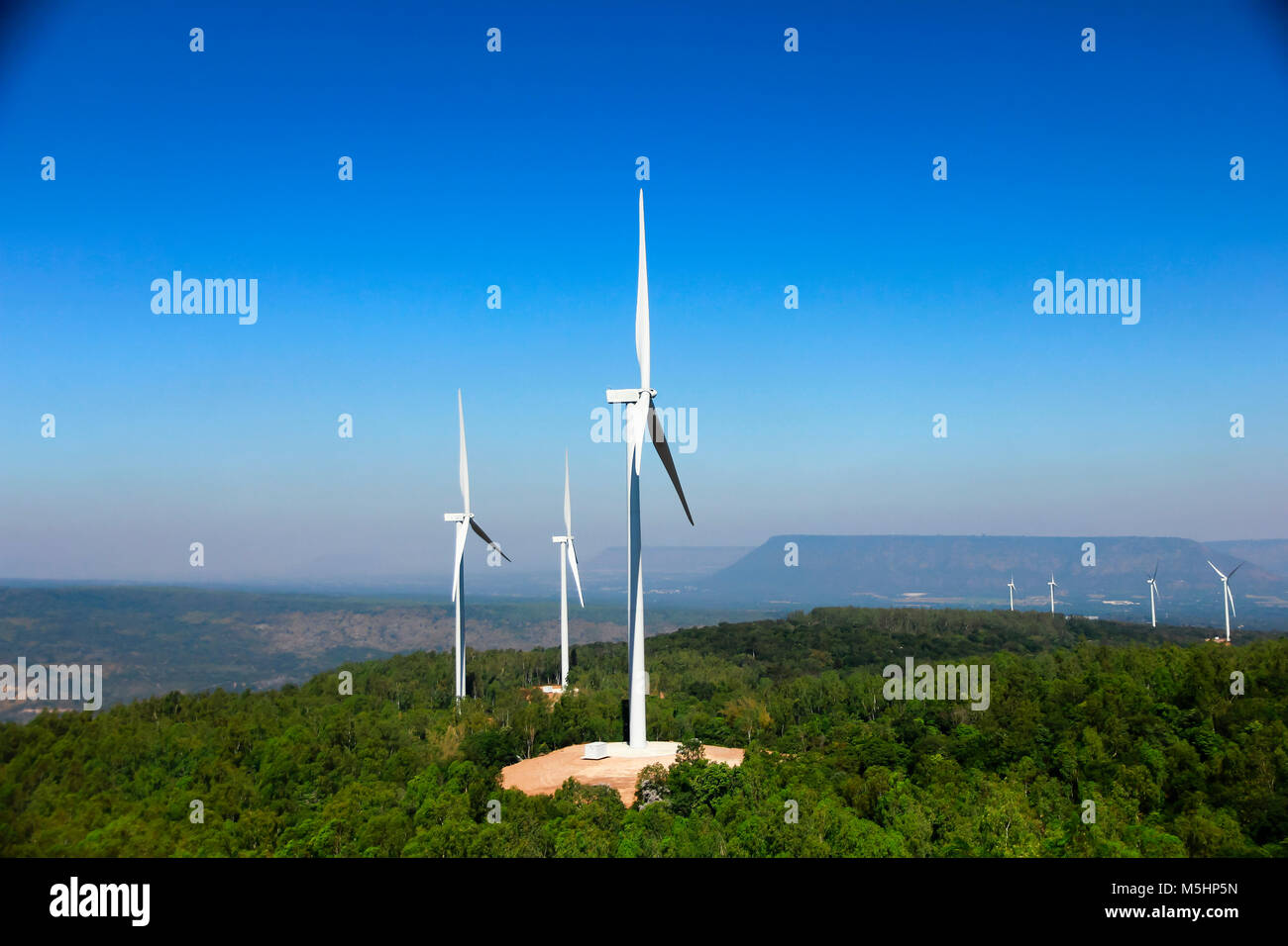 Wind turbine renewable energy source summer landscape with clear blue ...