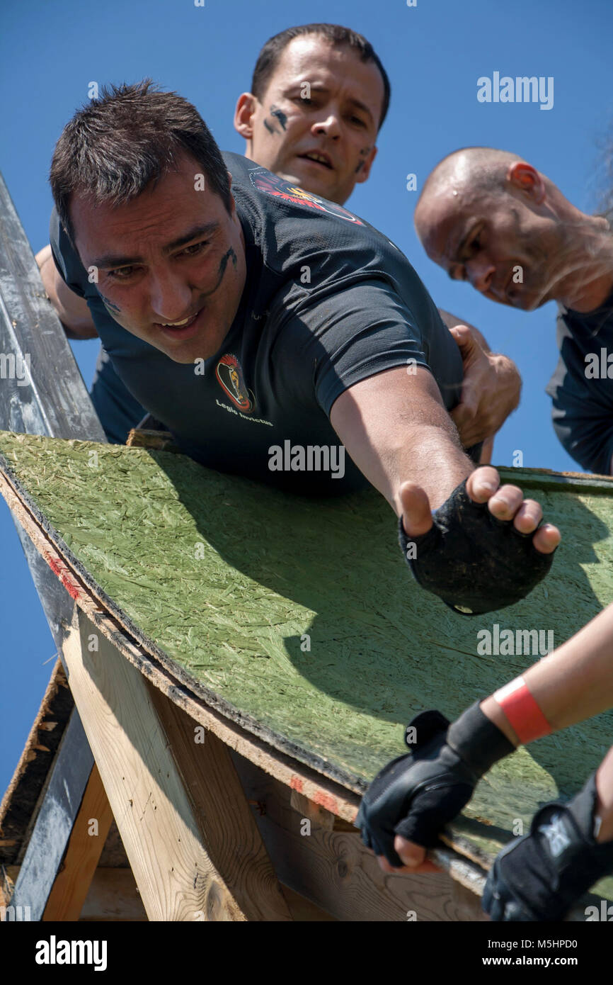 A man is reaching his hand to help a friendin a strength race Legion ...