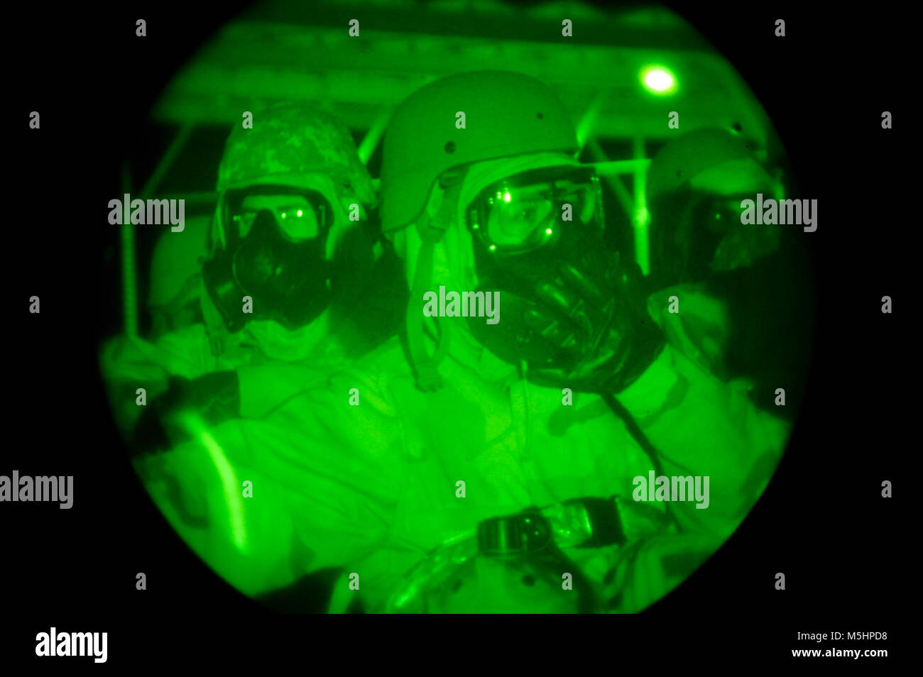 U.S. Airmen don their gas masks during a chemical, biological ...
