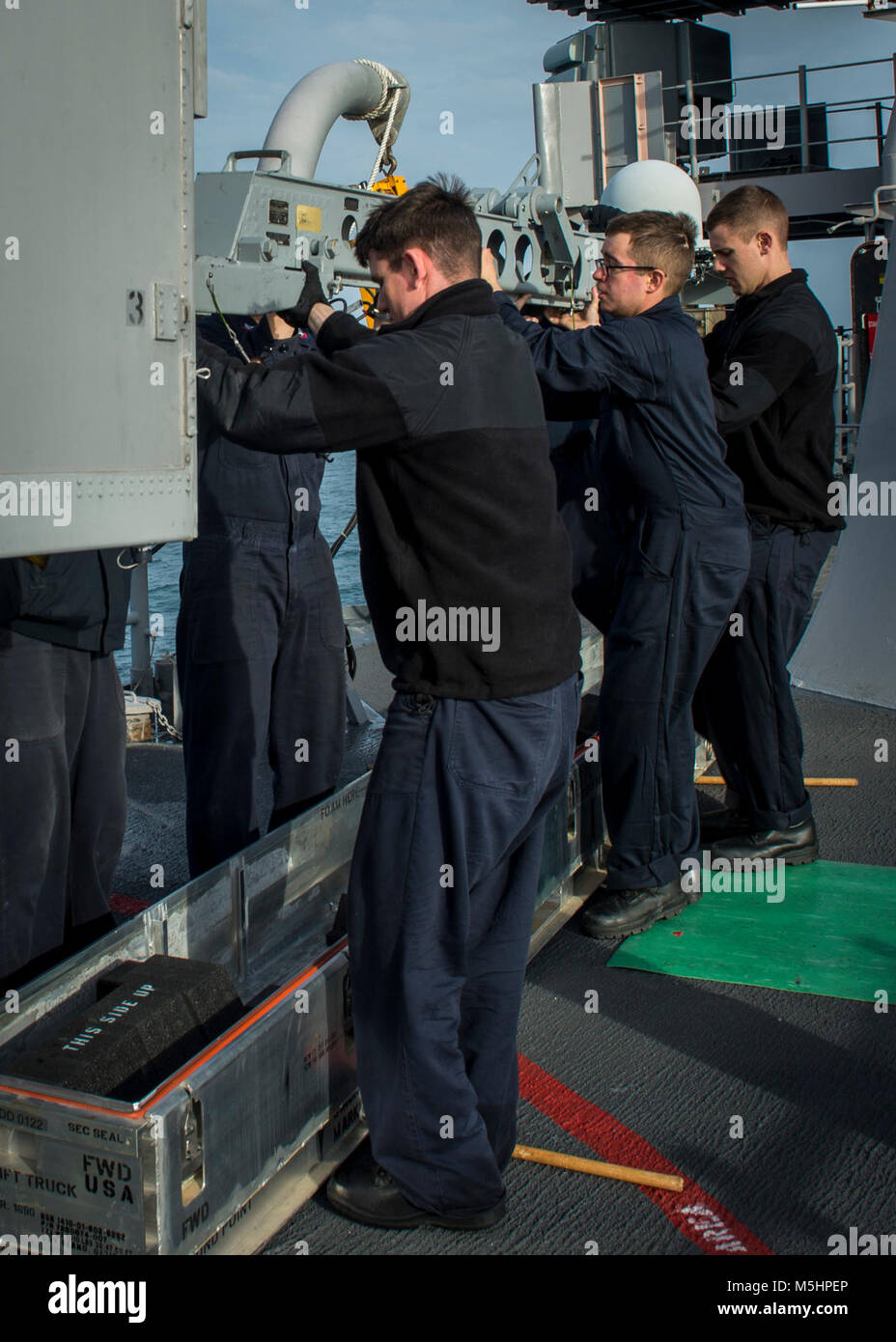 Sailors detach the guided-missile loader from the forward NATO ...