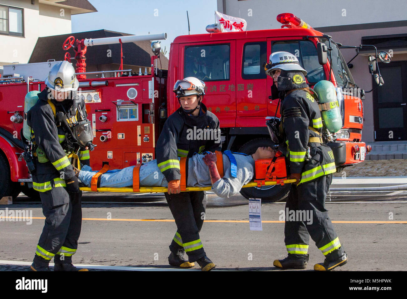 Iwakuni City Fire and Japanese emergency personnel move a simulated ...