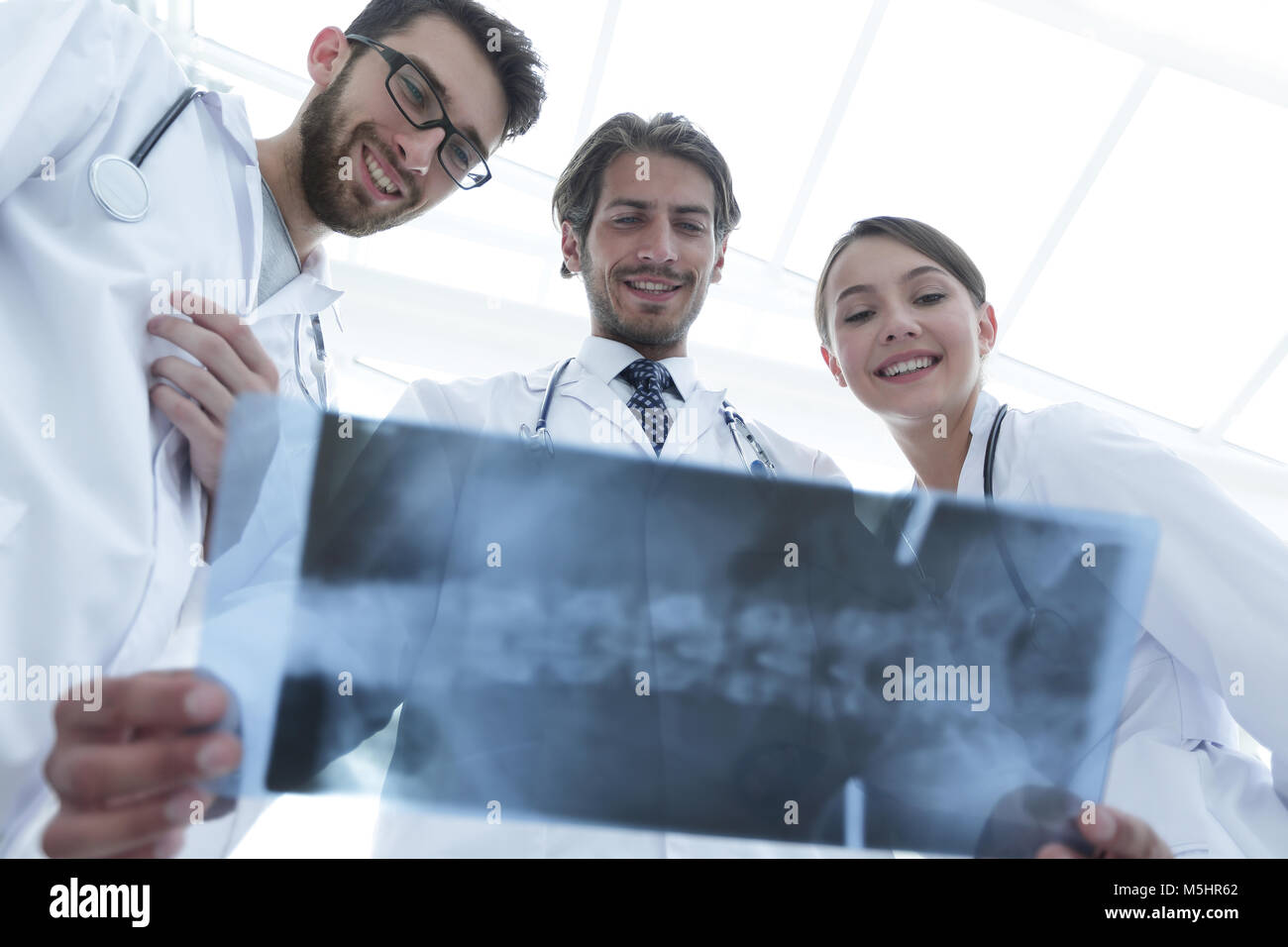bottom view young group of doctors looking at x-ray Stock Photo - Alamy