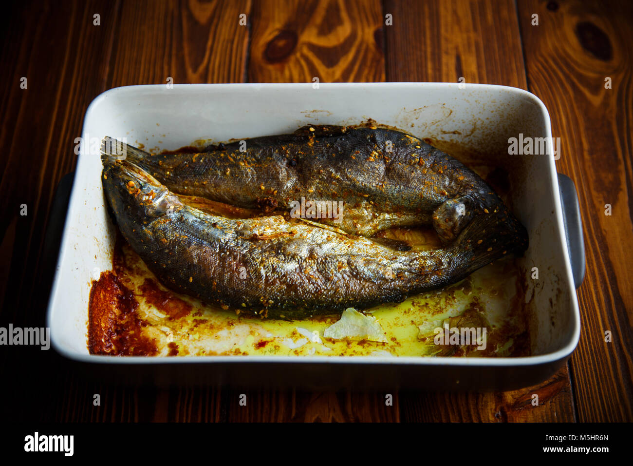 fish baked in ceramic form Stock Photo - Alamy