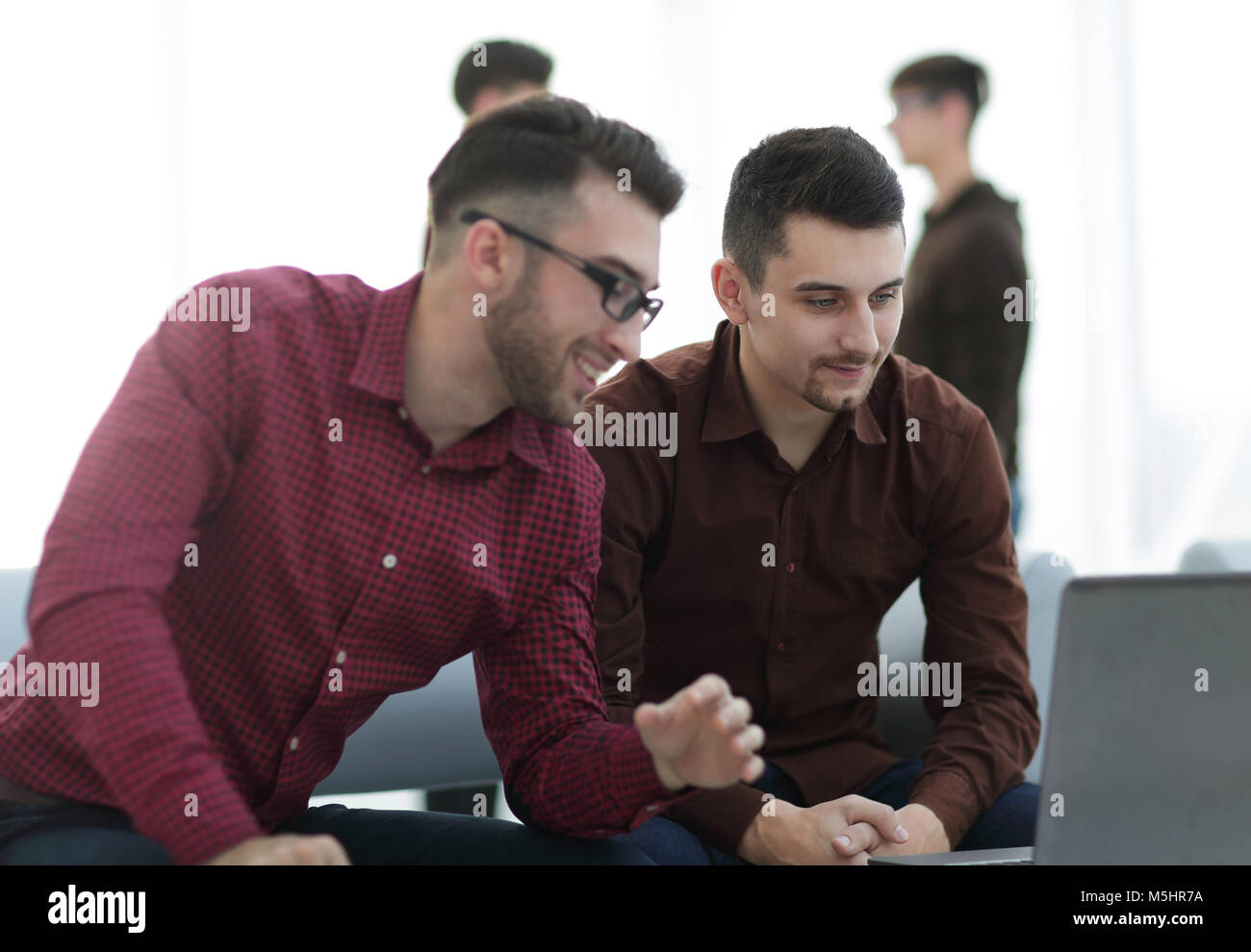 Two men working on laptop in the office Stock Photo - Alamy