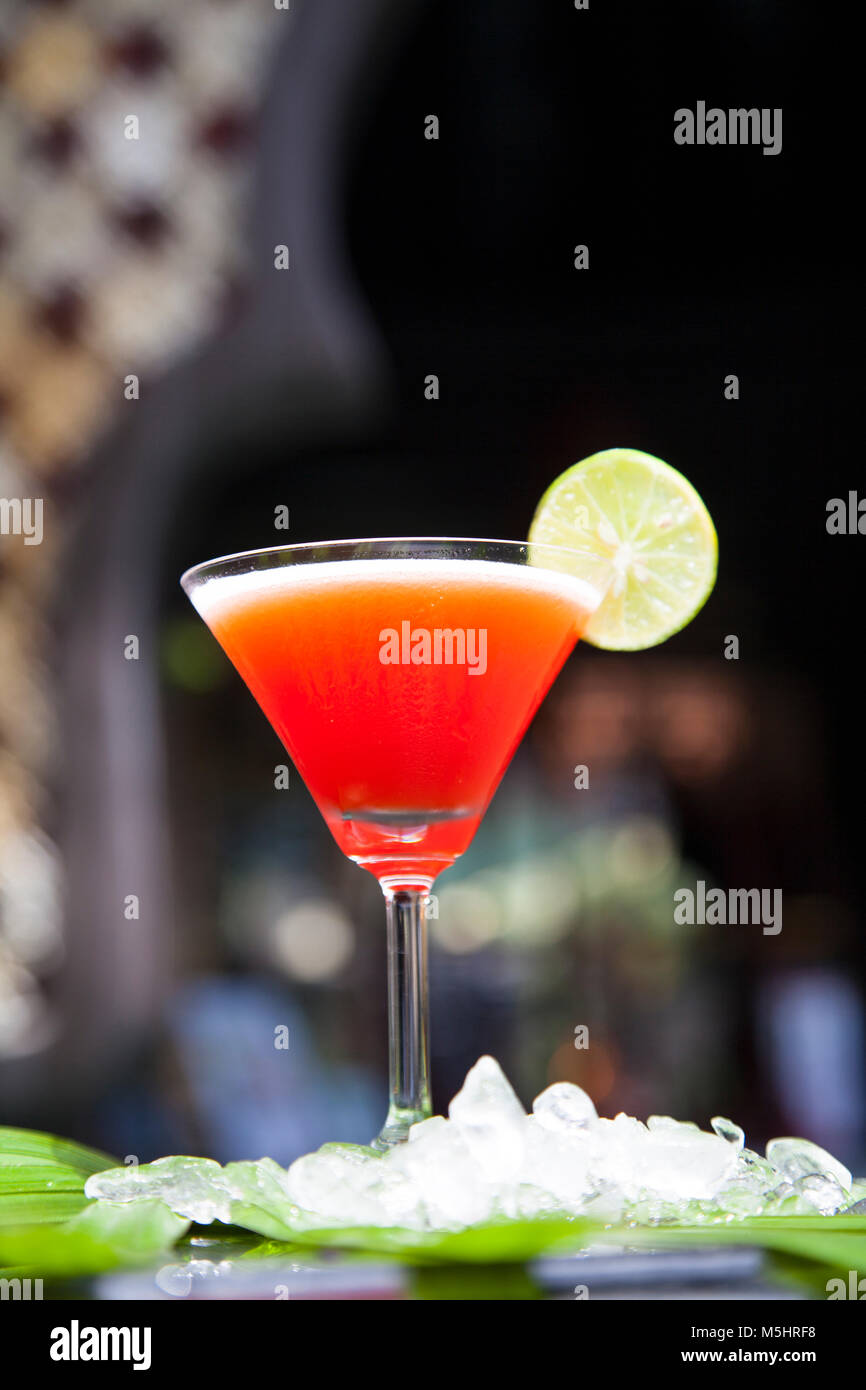 Cocktail on the background of the bar. Red alcoholic cocktail in a ...