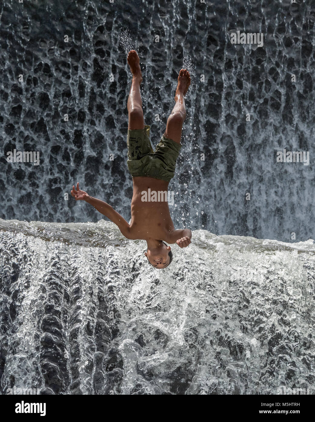 Back flip off the ledge, Tukad Unda Dam, Bali, Indonesia Stock Photo ...