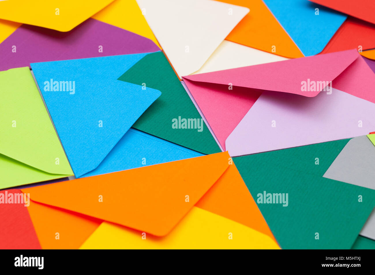 Different colored envelopes on the table Stock Photo - Alamy