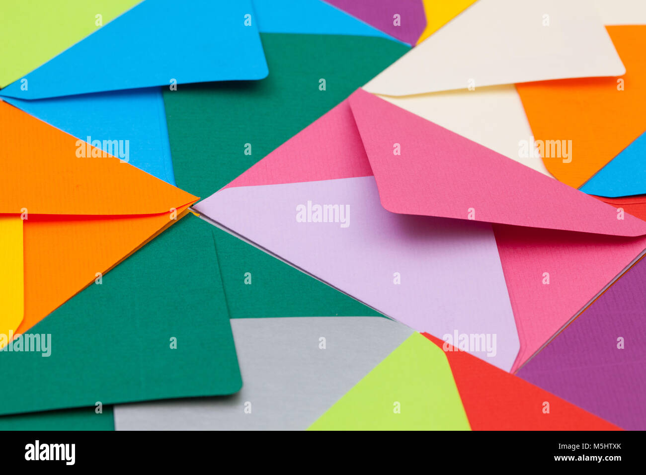 Different colored envelopes on the table Stock Photo - Alamy