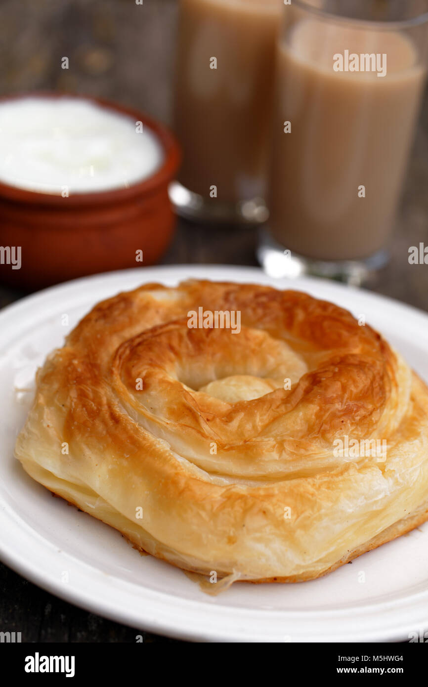 Traditional Bulgarian pastry Banitsa on a rustic table with Greek ...