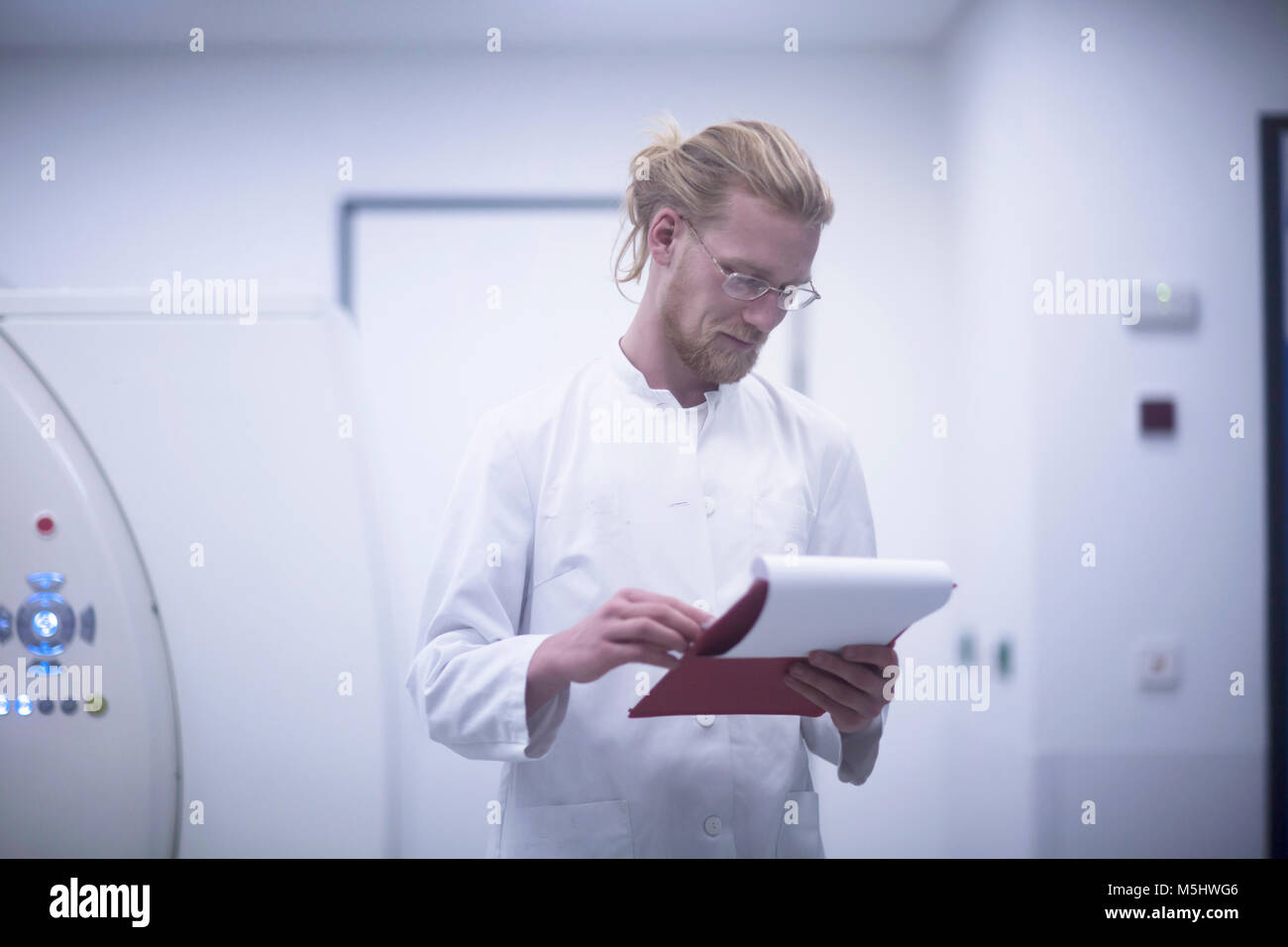 Radiologist checking notes Stock Photo - Alamy
