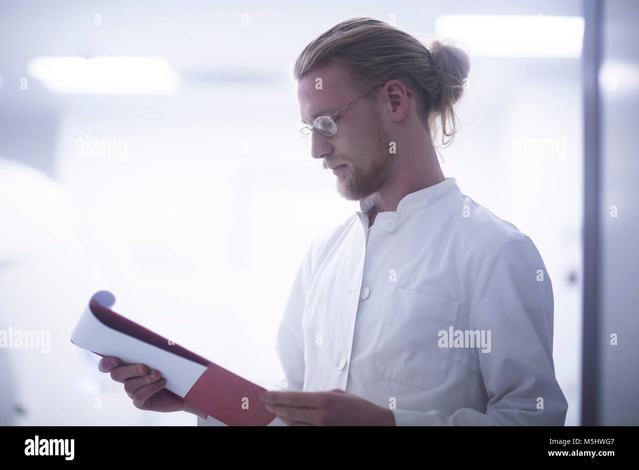 Radiologist checking notes Stock Photo - Alamy