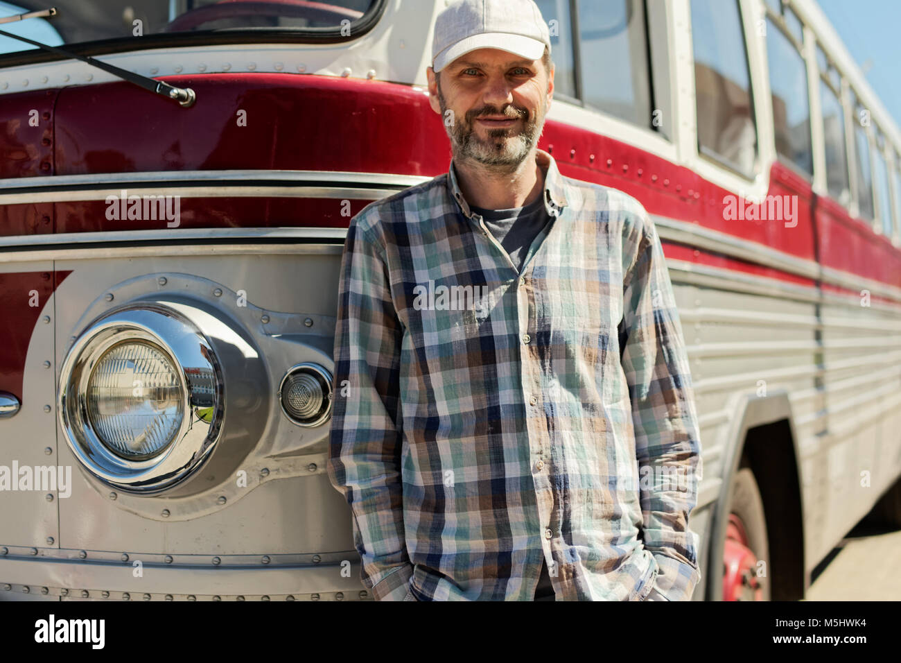 Mature man standing against the Soviet retro styled coach bus Stock ...